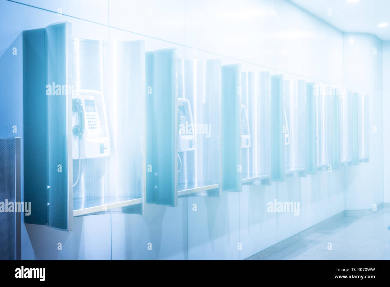 Perspective row of public telephone inside modern building Stock Photo ...