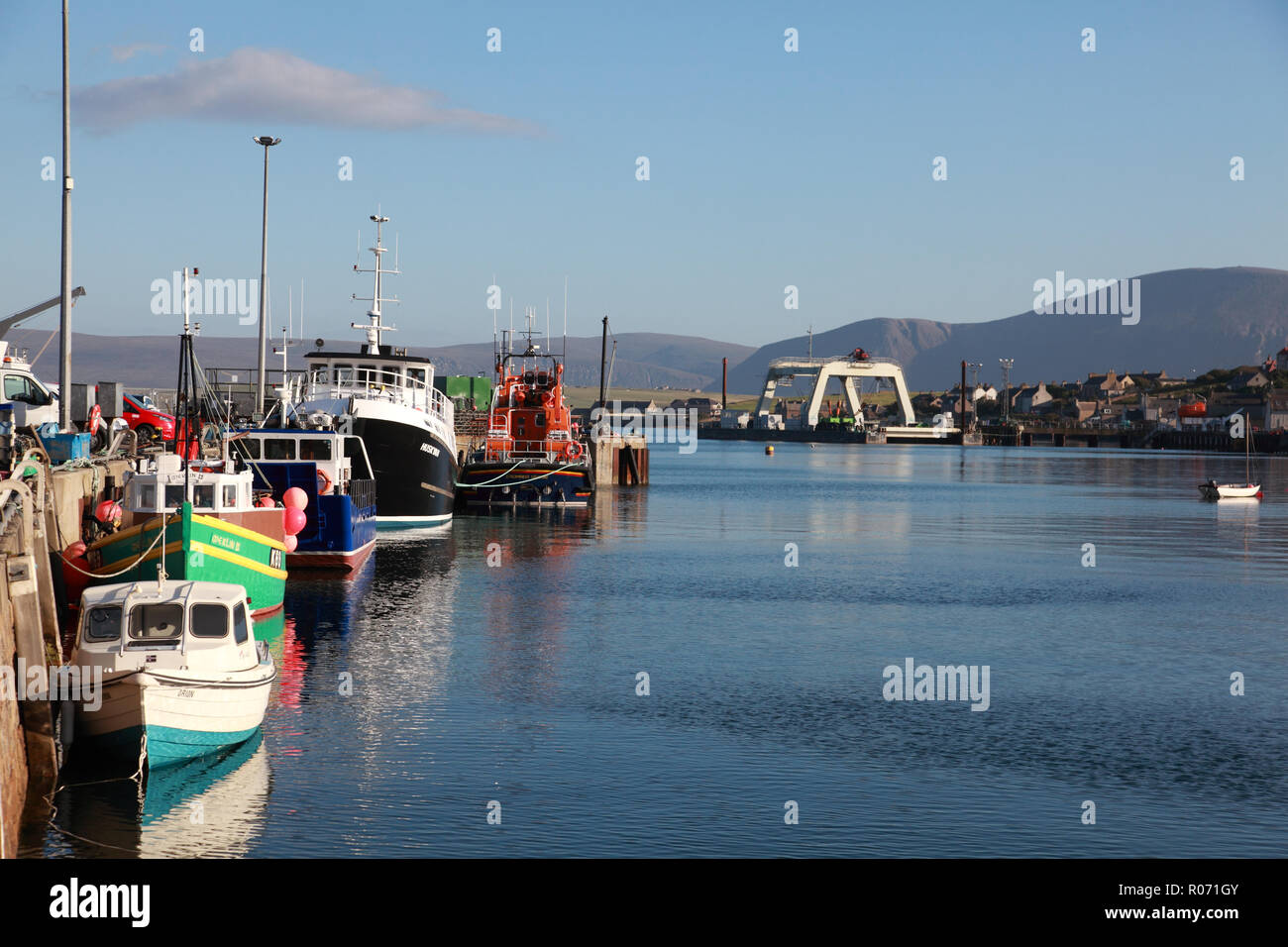 The harbour in Stromness, Orkney with fishing boats, the lifeboat and ...