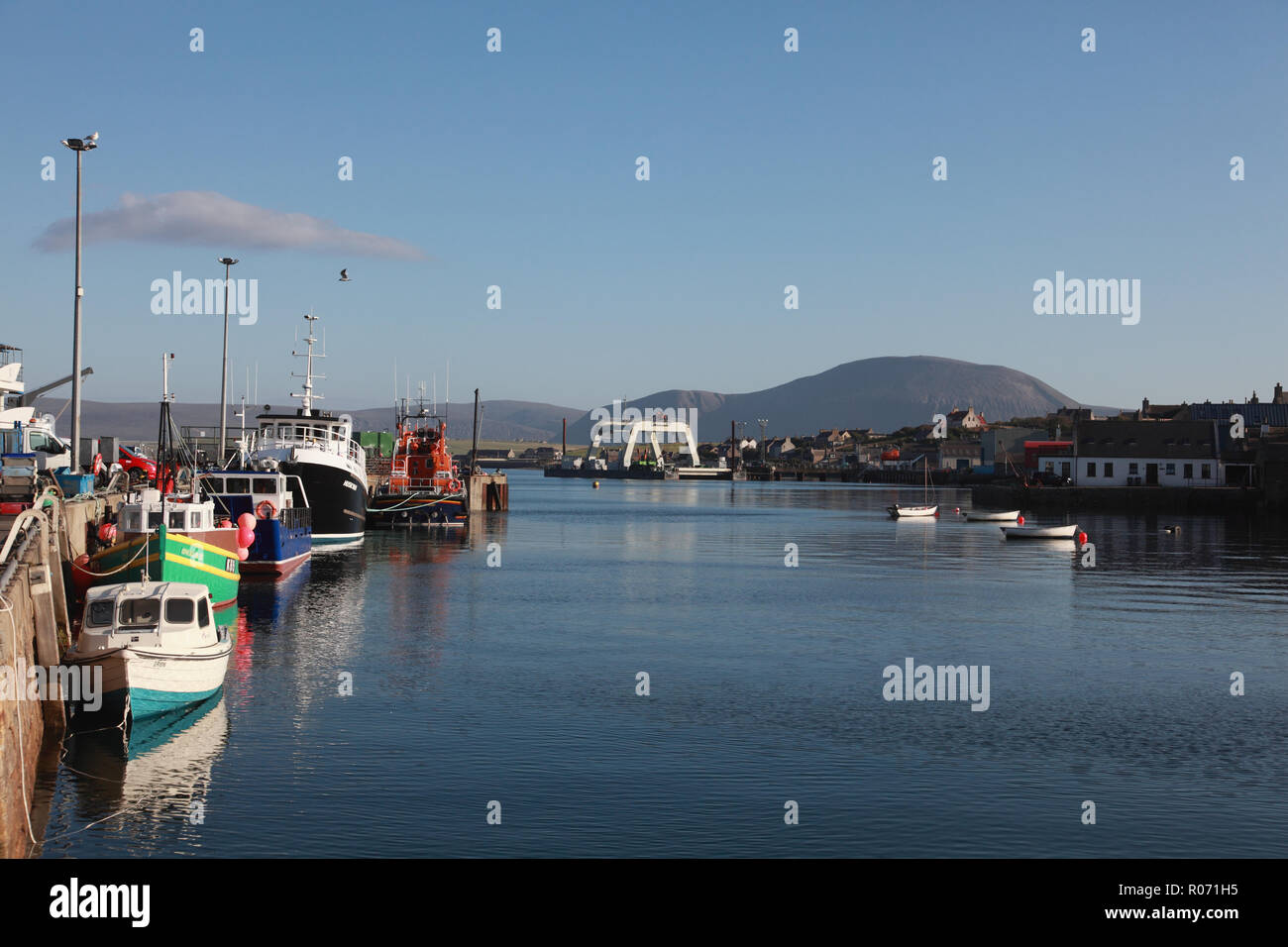 The harbour in Stromness, Orkney with fishing boats, the lifeboat and ...