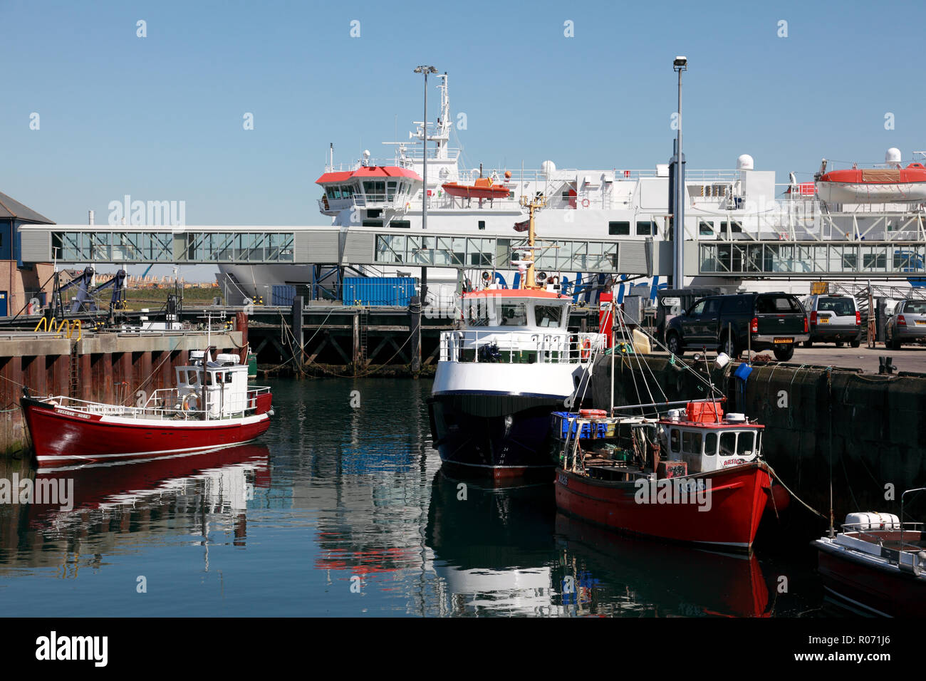 The harbour in Stromness, Orkney with fishing boats and the NorthLink ...