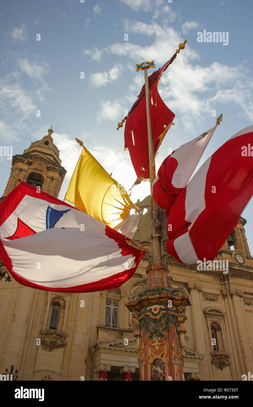 Waving red, yellow and white flags on festively decorated square near ...