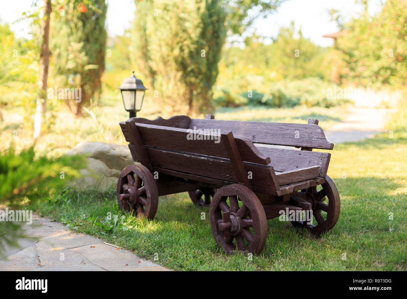 Wooden cart as decoration in the rark Stock Photo - Alamy
