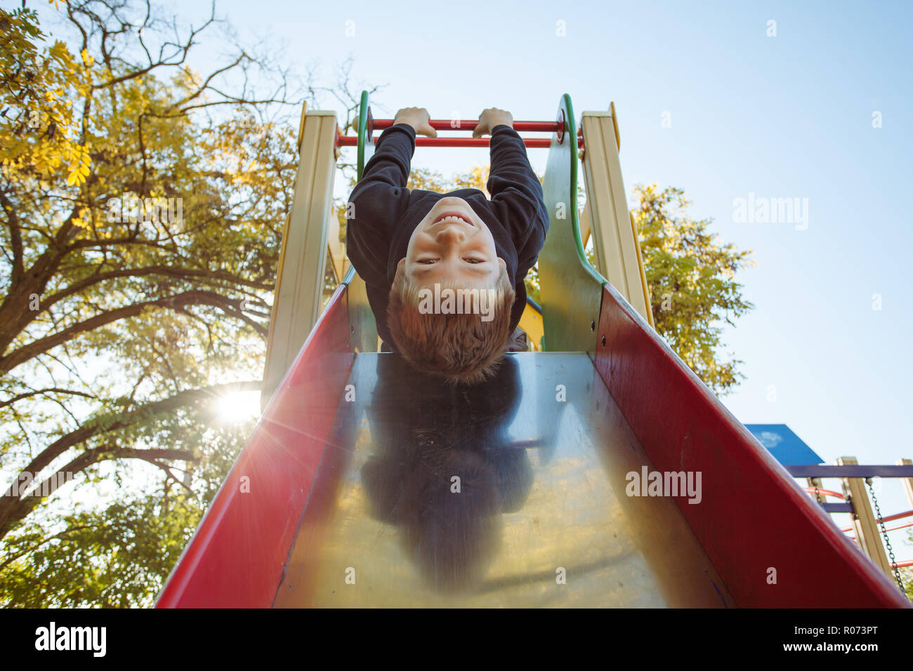 Boy playing at playground Stock Photo - Alamy