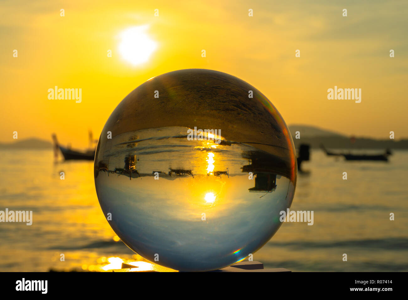 crystal glass ball sphere reveals sunrise seascape with spherical ...