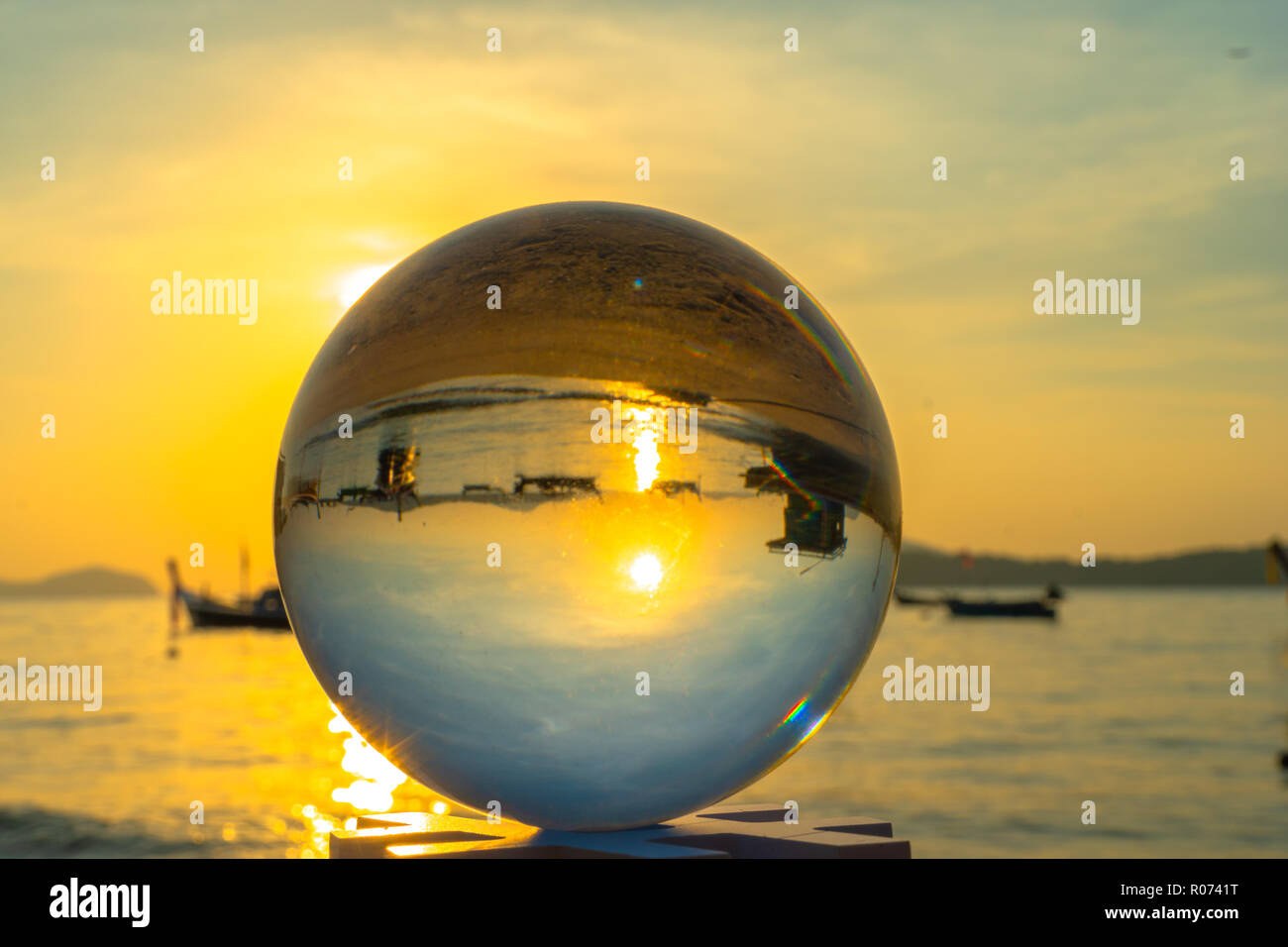 crystal glass ball sphere reveals sunrise seascape with spherical ...