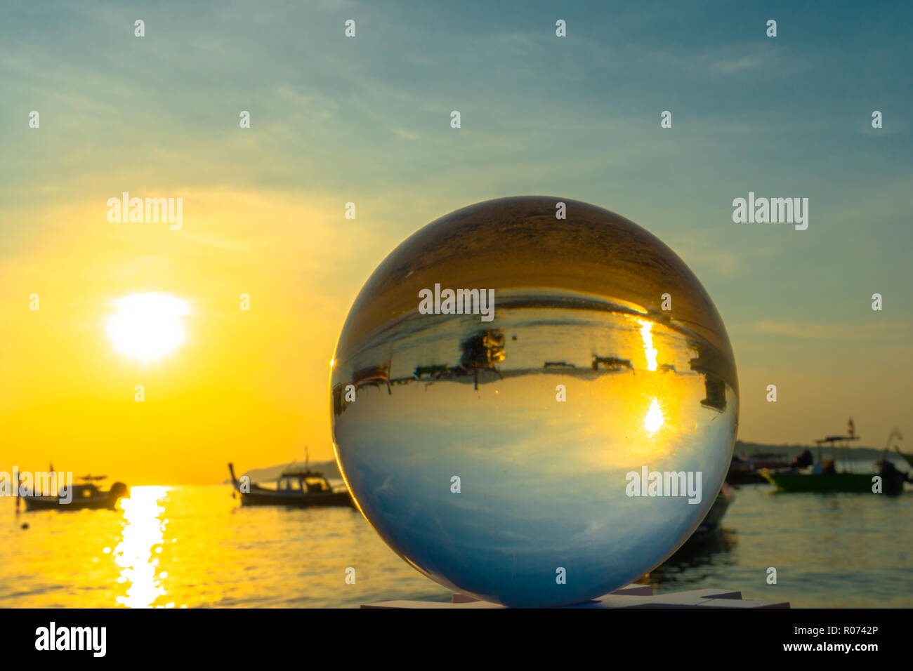 crystal glass ball sphere reveals sunrise seascape with spherical ...