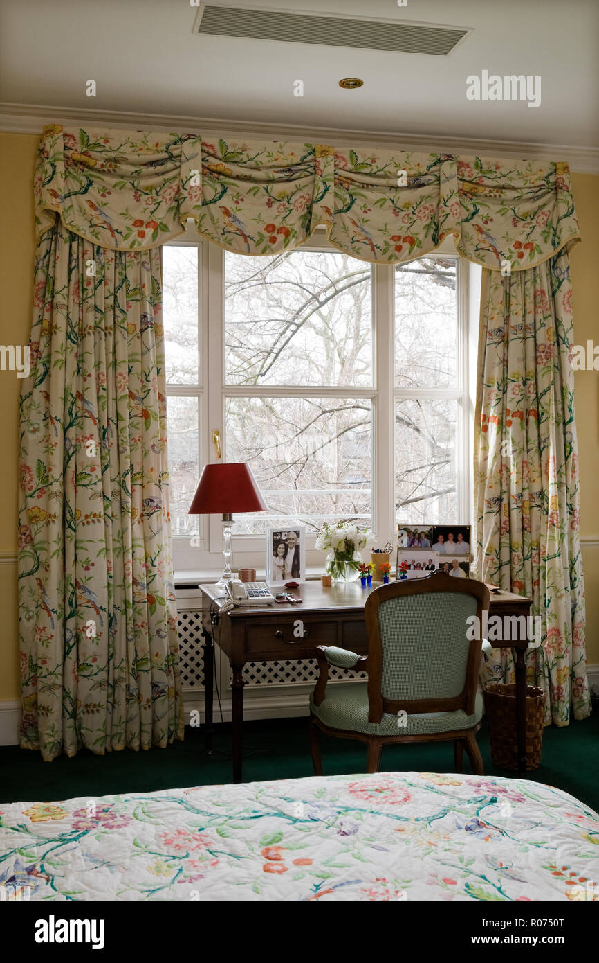 Desk by window with floral curtains Stock Photo - Alamy