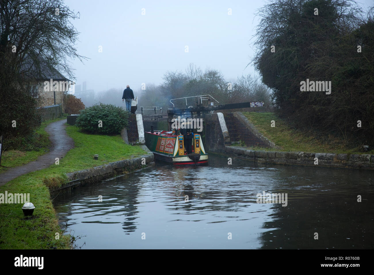 Traditional narrowboat enters lock on the Grand Union Canal heading ...