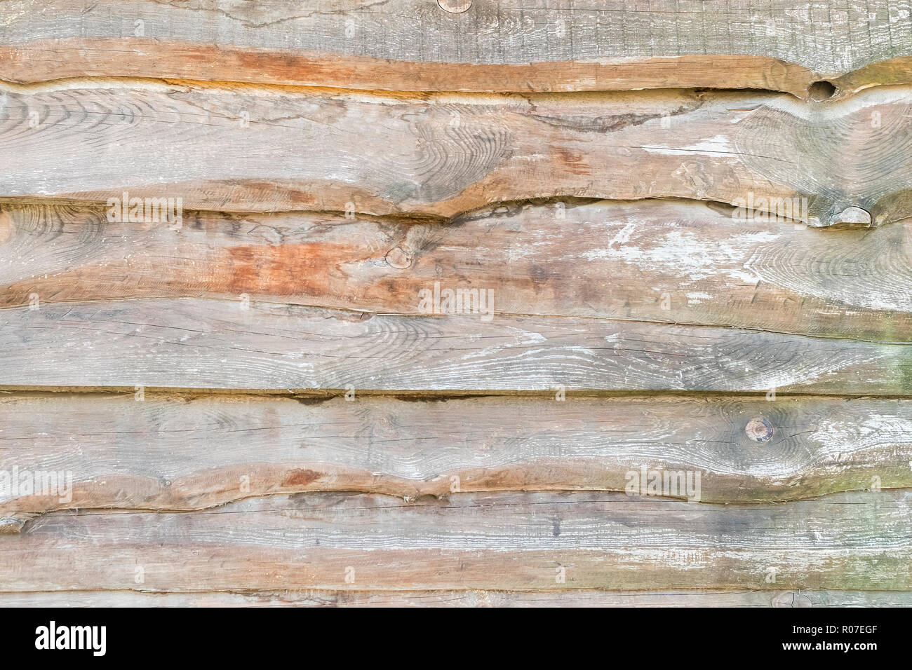Wall from old edging boards overlapped on each other as a background ...