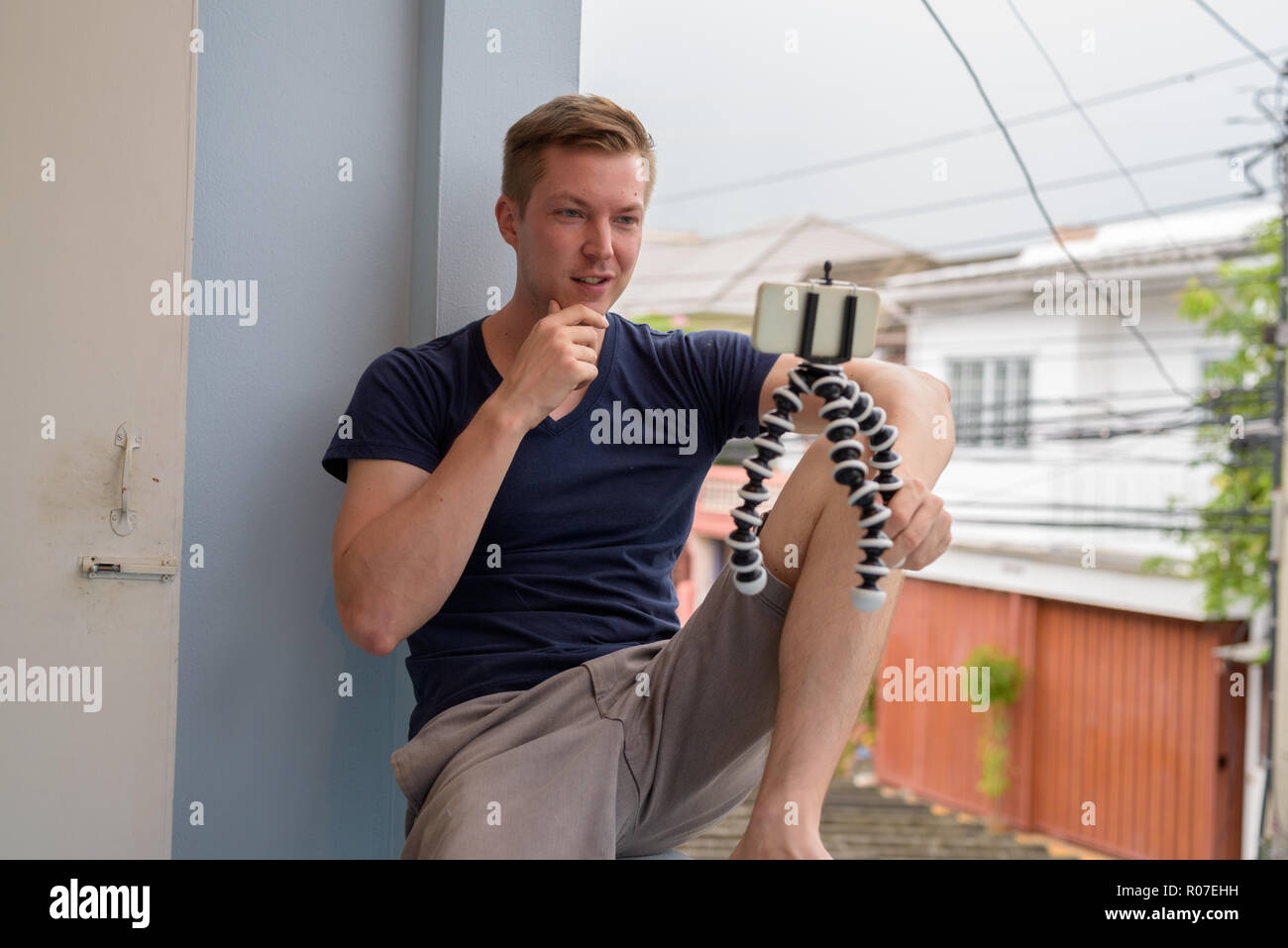 Portrait of young handsome man vlogging at home Stock Photo - Alamy