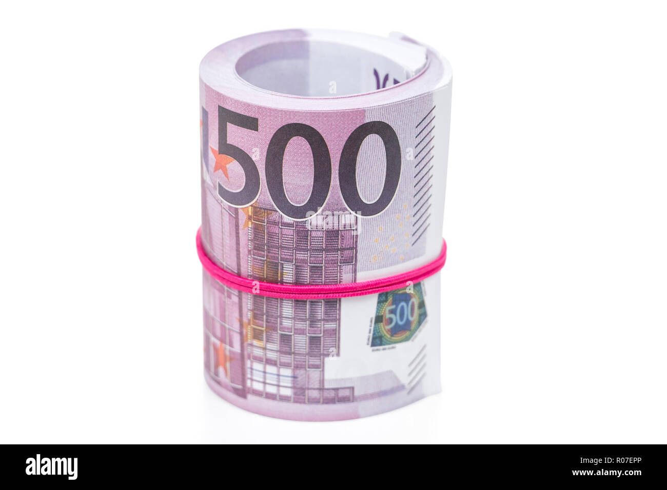 bundle of money in denominations of five hundred euro tied with a ...