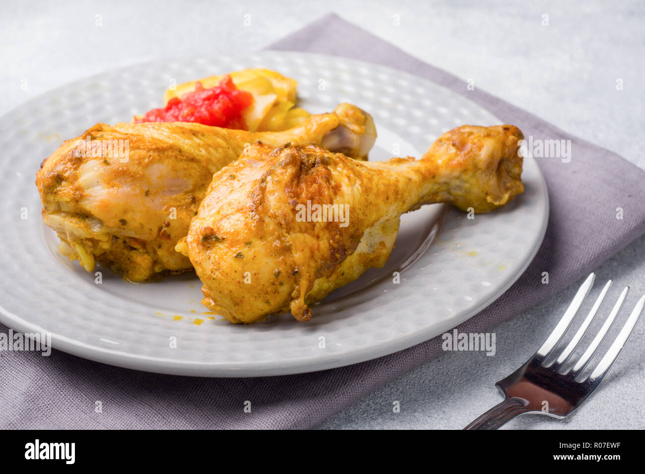 Baked chicken leg Shin with vegetables tomato zucchini on a plate Stock ...