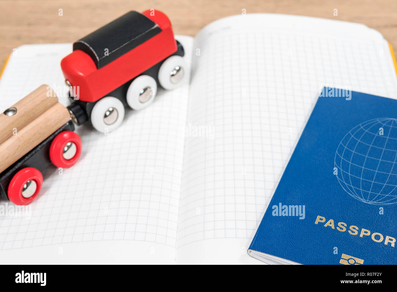 Concept planning an overseas trip by train with a toy train, a passport ...
