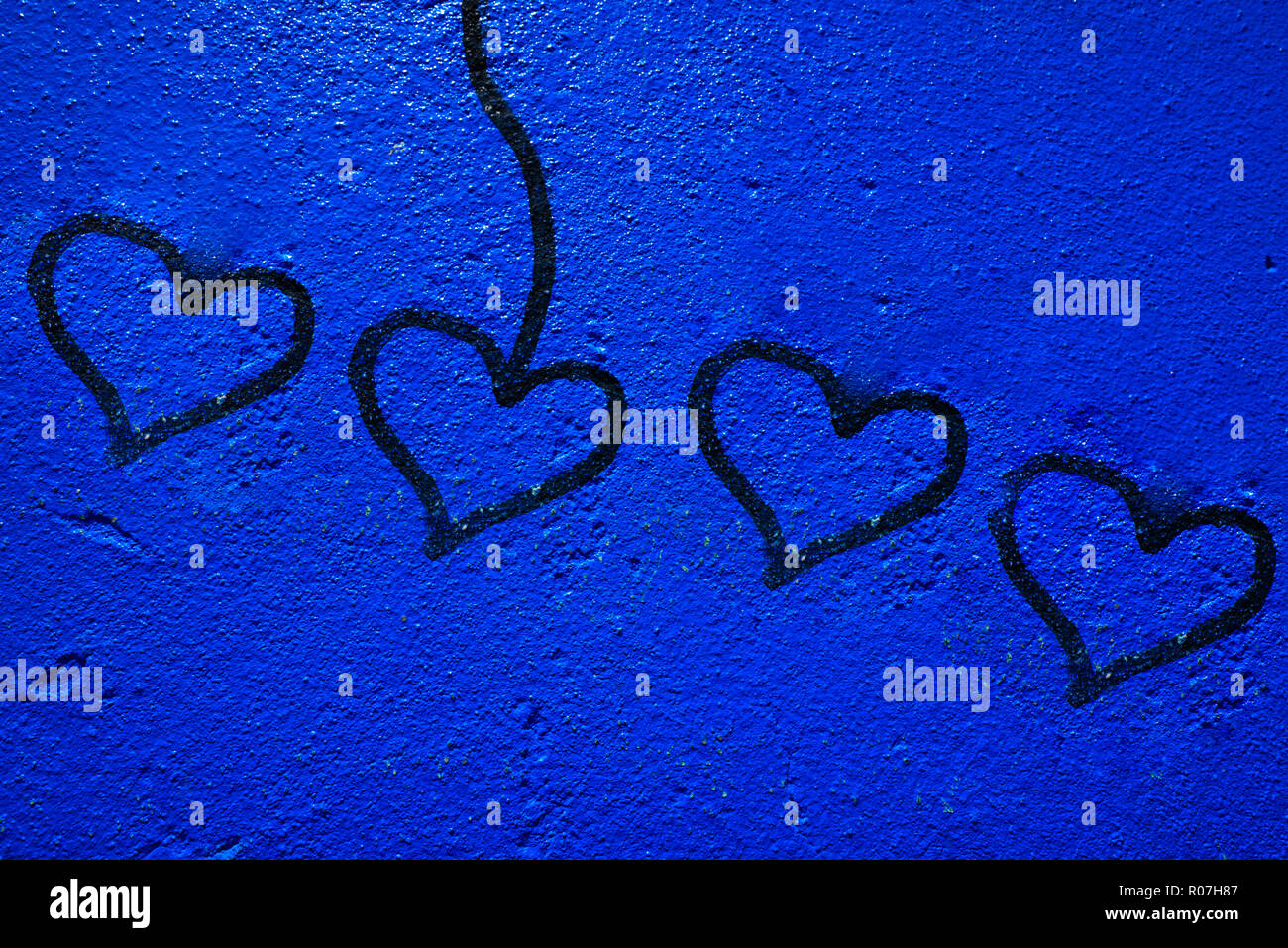Blue painted wall background with heart signs Stock Photo - Alamy