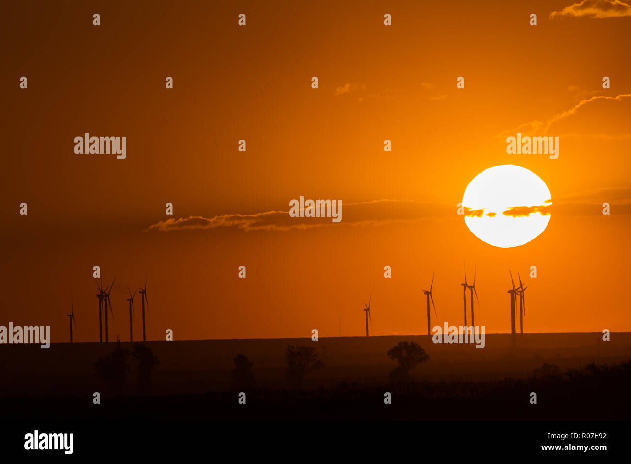 Beautiful sunset with wind turbines silhouettes on hill Stock Photo - Alamy