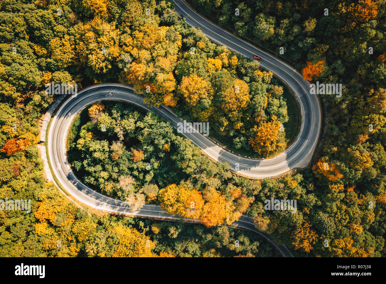 Extreme curved winding road in the forest aerial photography Stock ...
