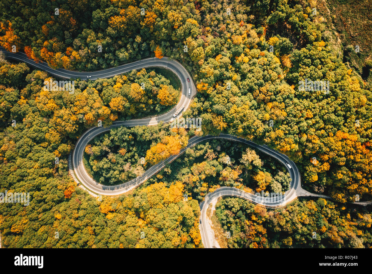 Road seen from above. Aerial view of an extreme winding curved road in ...
