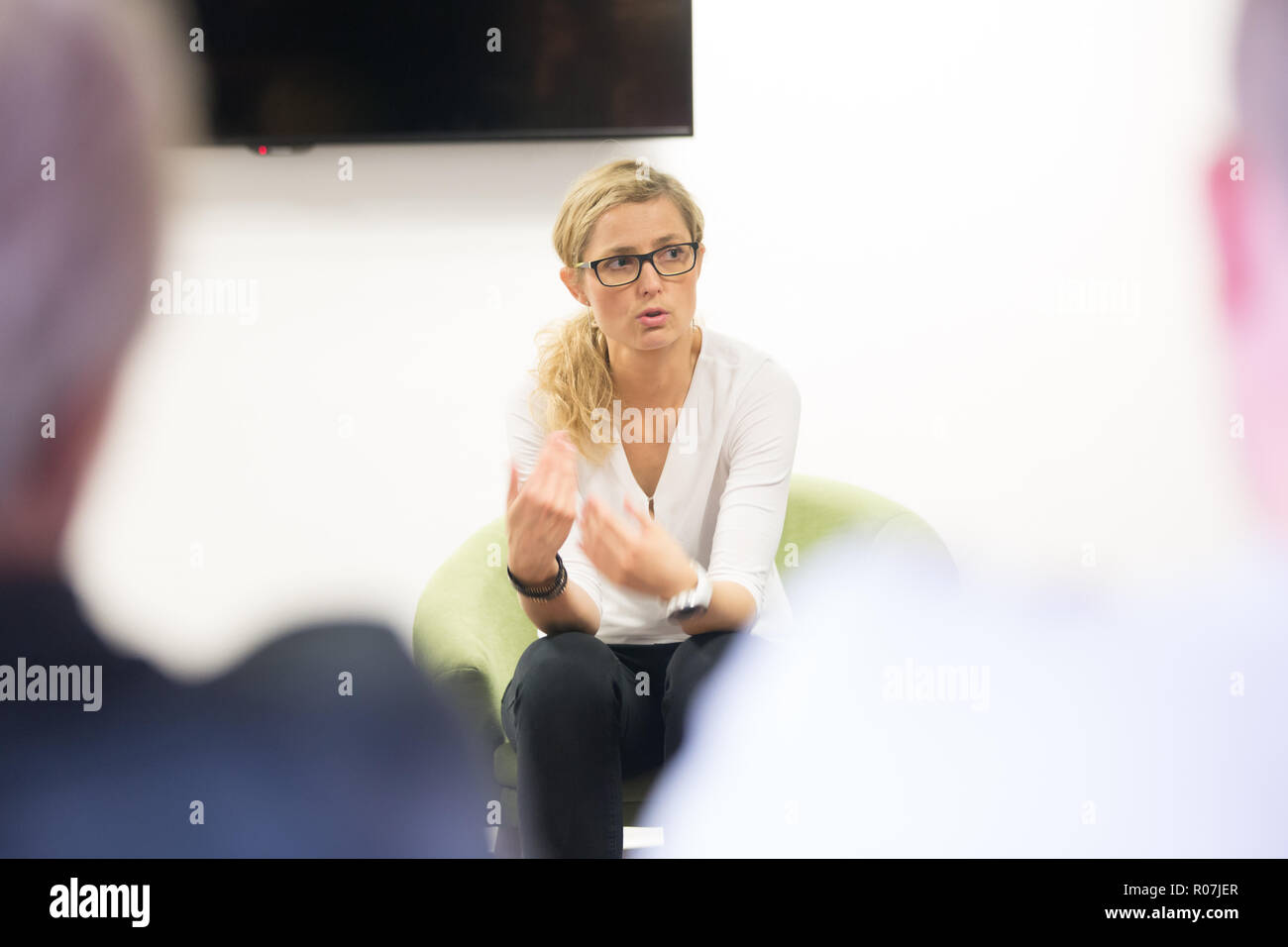 Female candidate presenting her CV in front of business job recuters ...