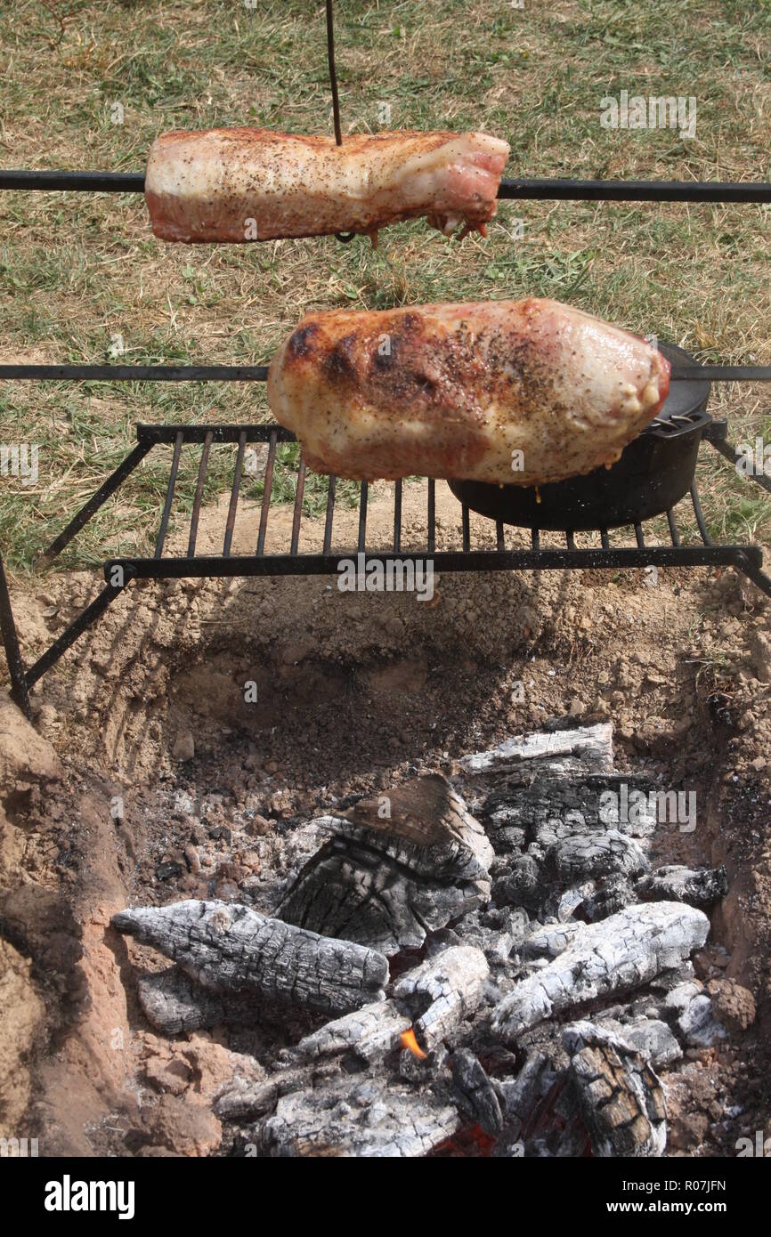 Old-style outdoors cooking over open fire Stock Photo - Alamy