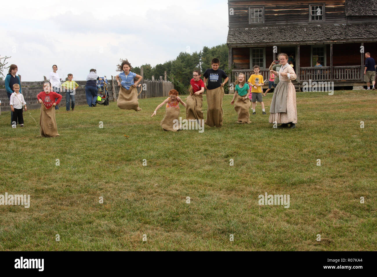 Children competing in a potato sack race at the Frontier Culture Museum ...