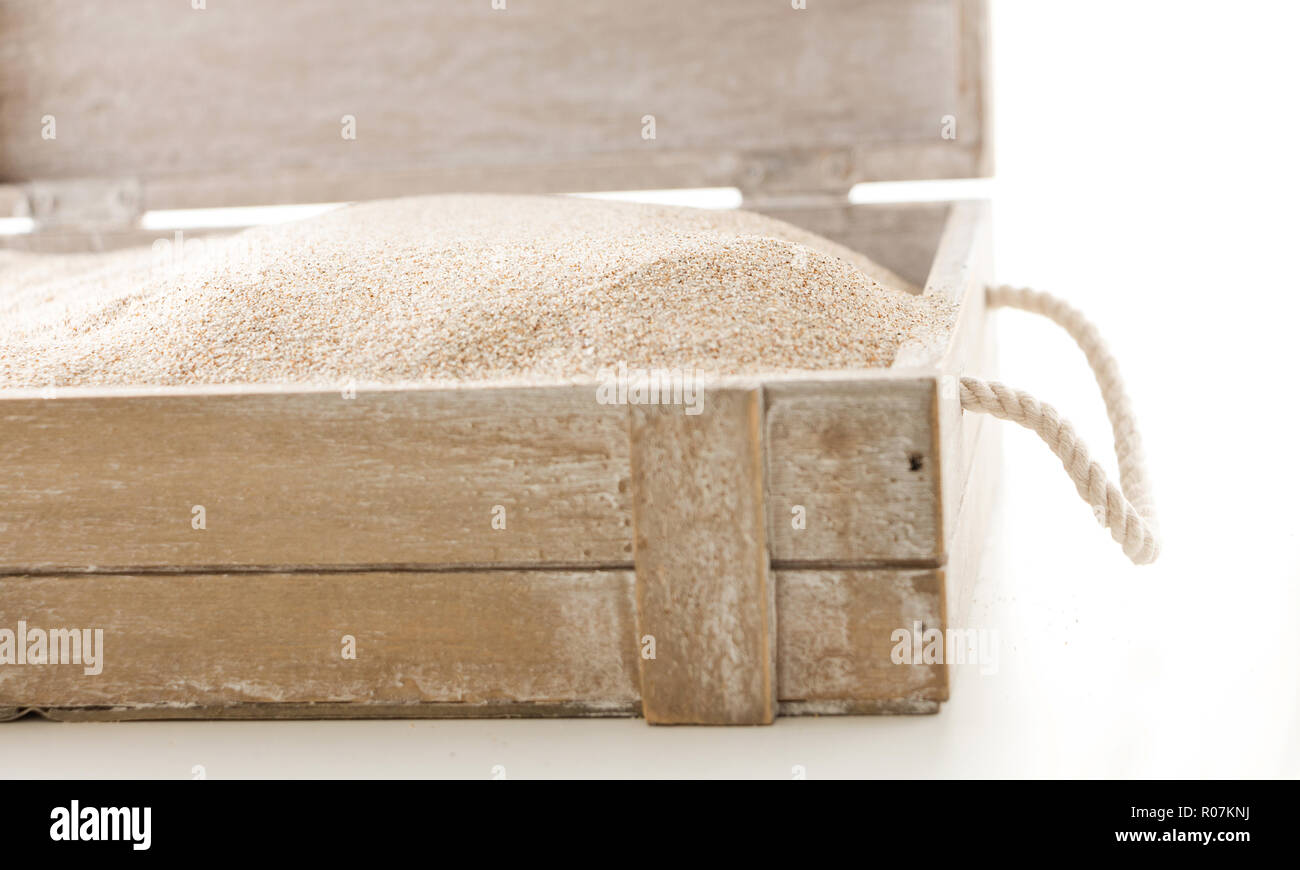 Opened wooden chest full with sand, on white background Stock Photo - Alamy