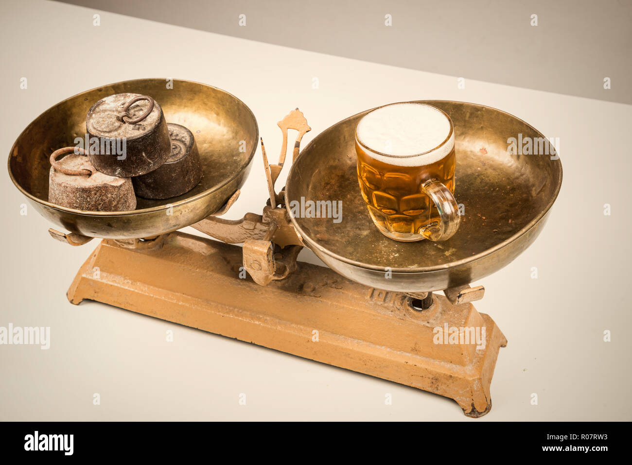 Beer on vintage scales, an alcoholism concept Stock Photo - Alamy