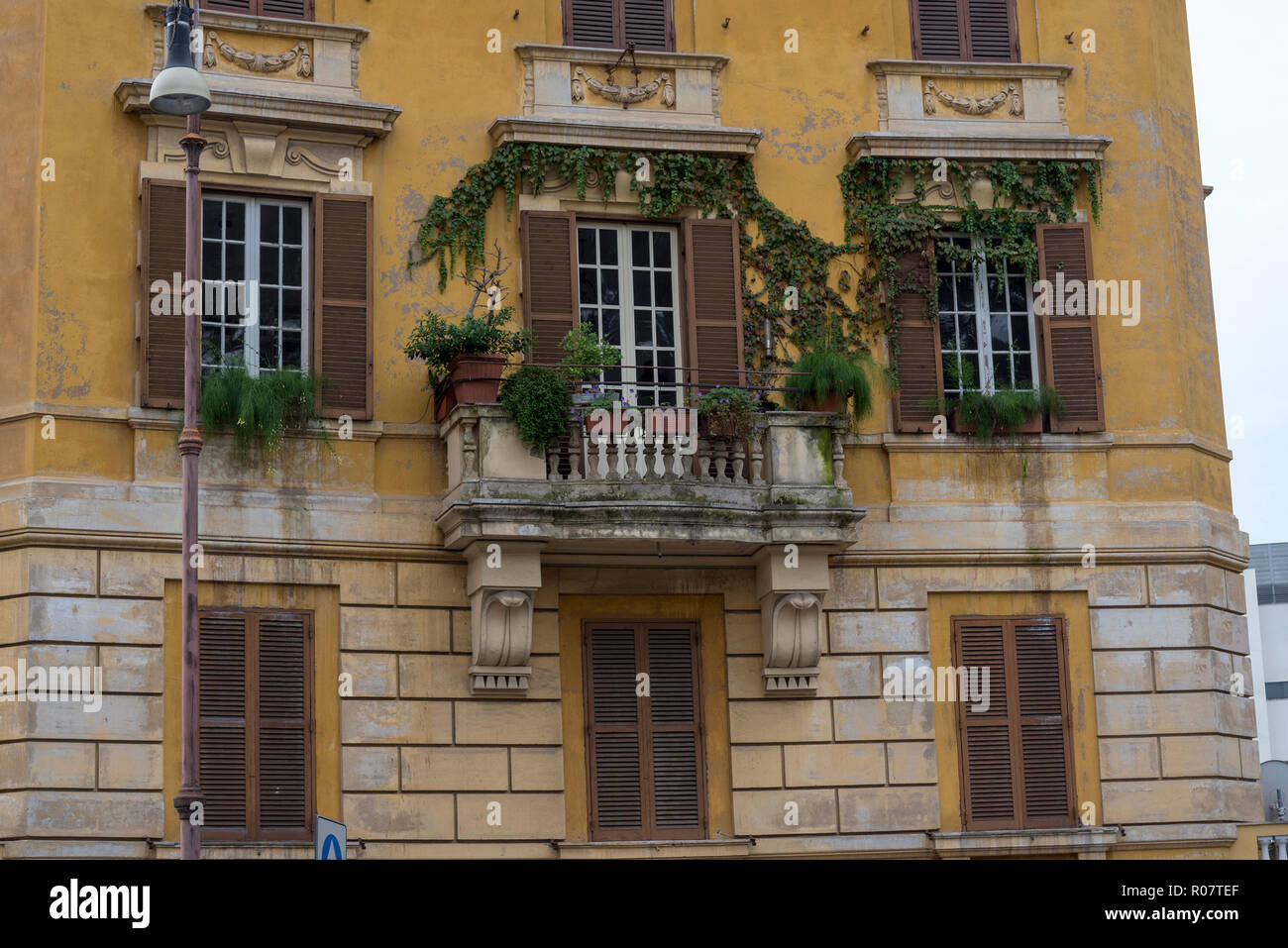 Windows and balcony of an old house in Italy. The facade of the house ...
