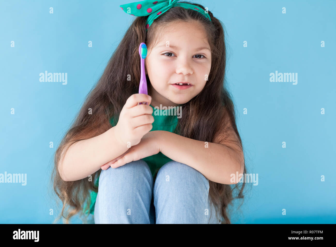 little girl with no teeth with a toothbrush in dentistry Stock Photo ...