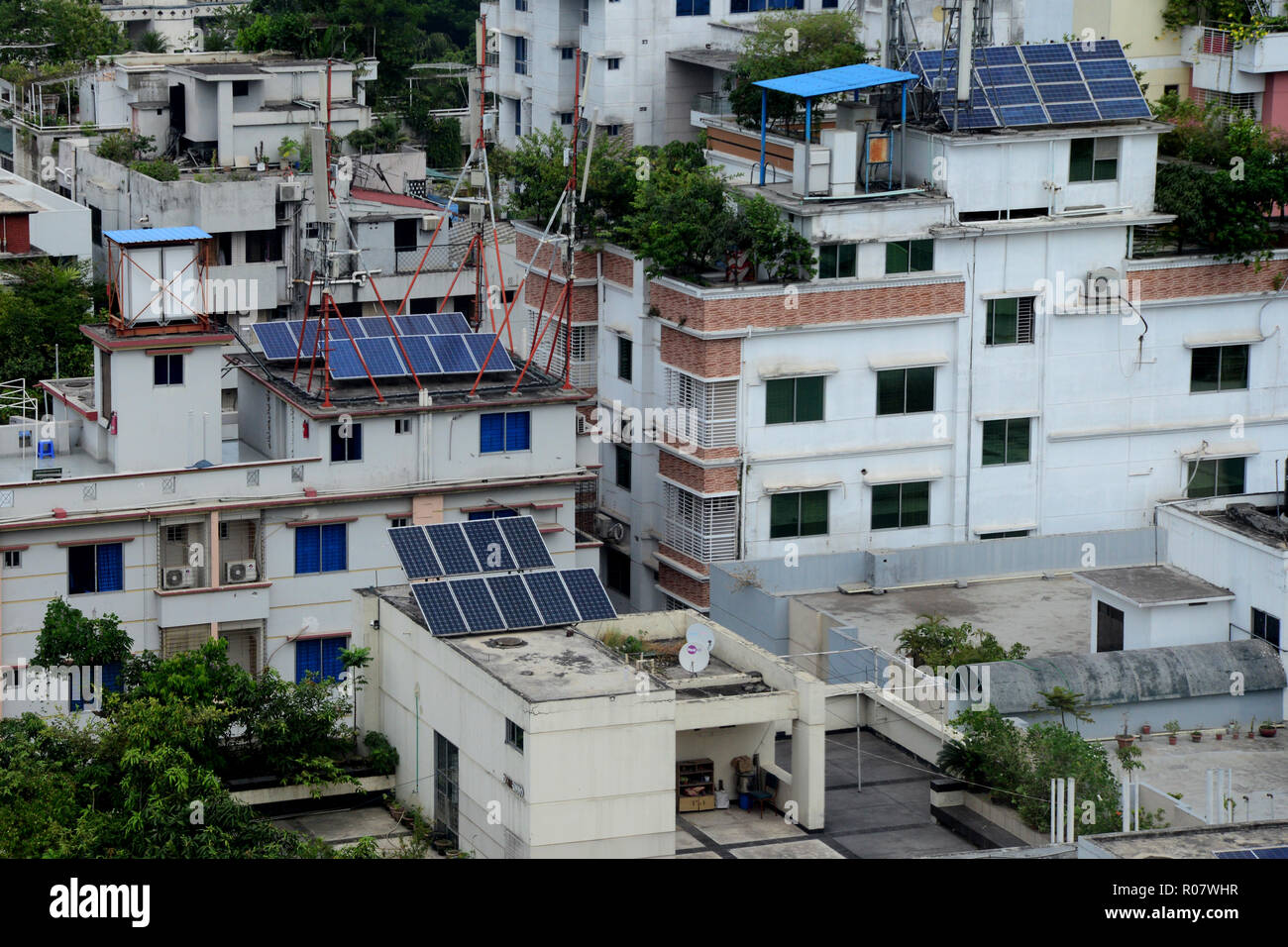 A solar energy panel is seen on the rooftops of buildings in Dhaka ...