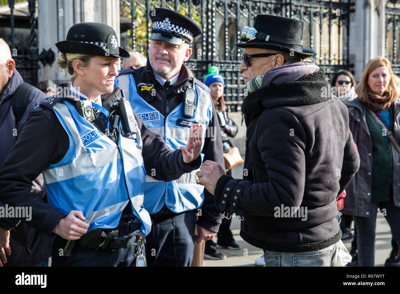London, UK. 31st October, 2018. A man tells police officers that they ...