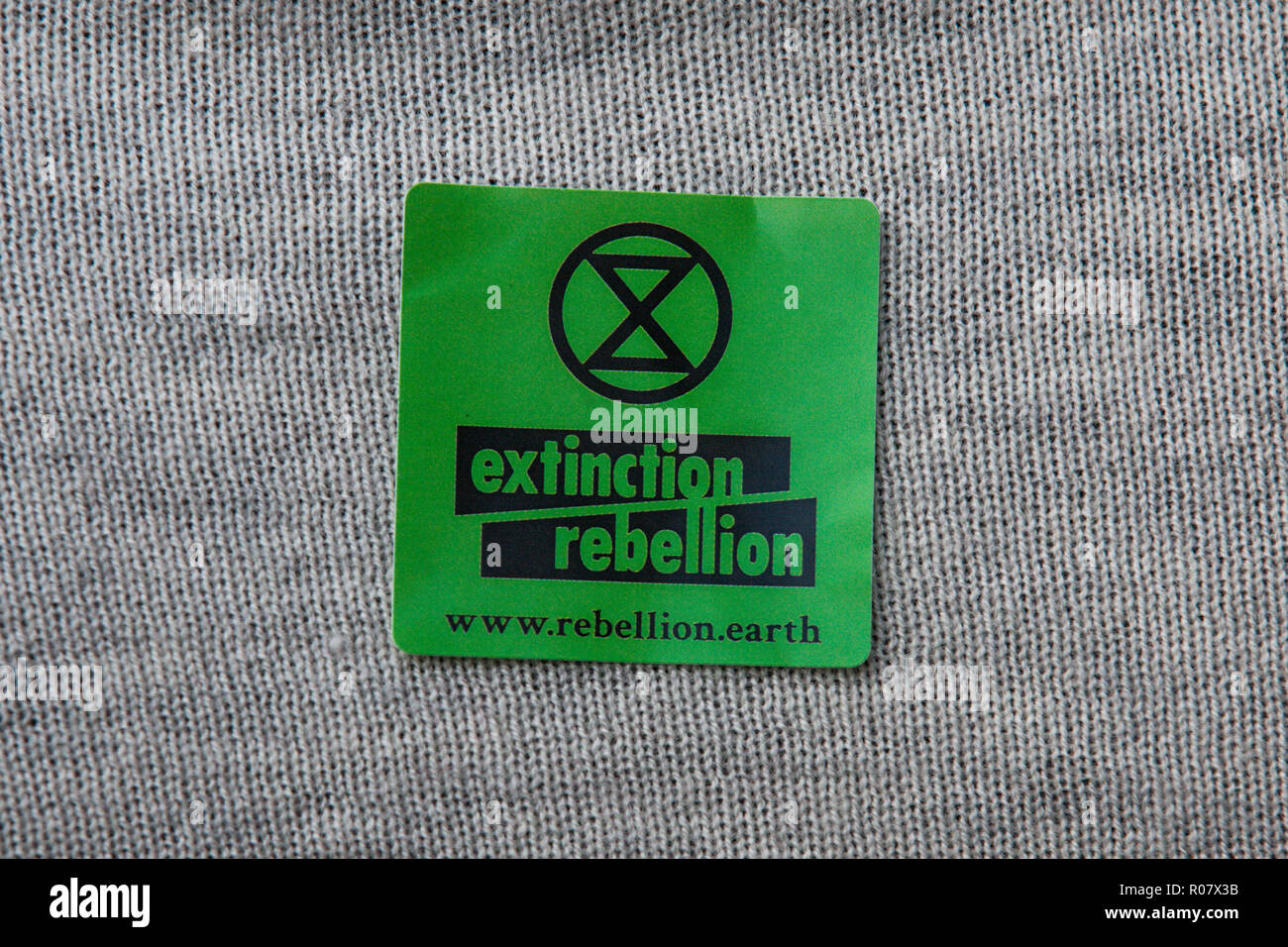 London, UK. 31st October, 2018. An Extinction Rebellion sticker worn by ...