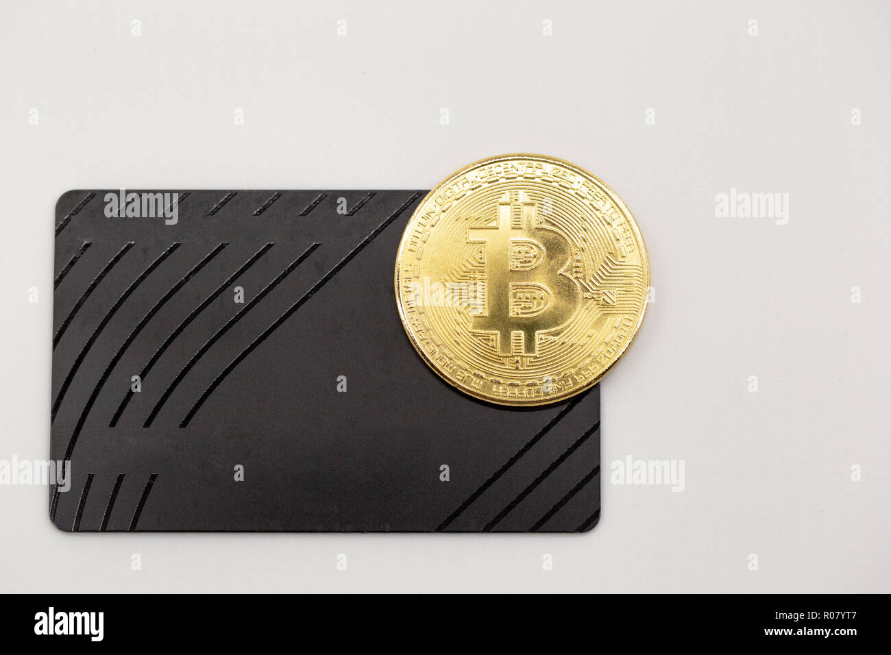 Bitcoin token on top of black credit card. Cryptocurrency versus credit ...