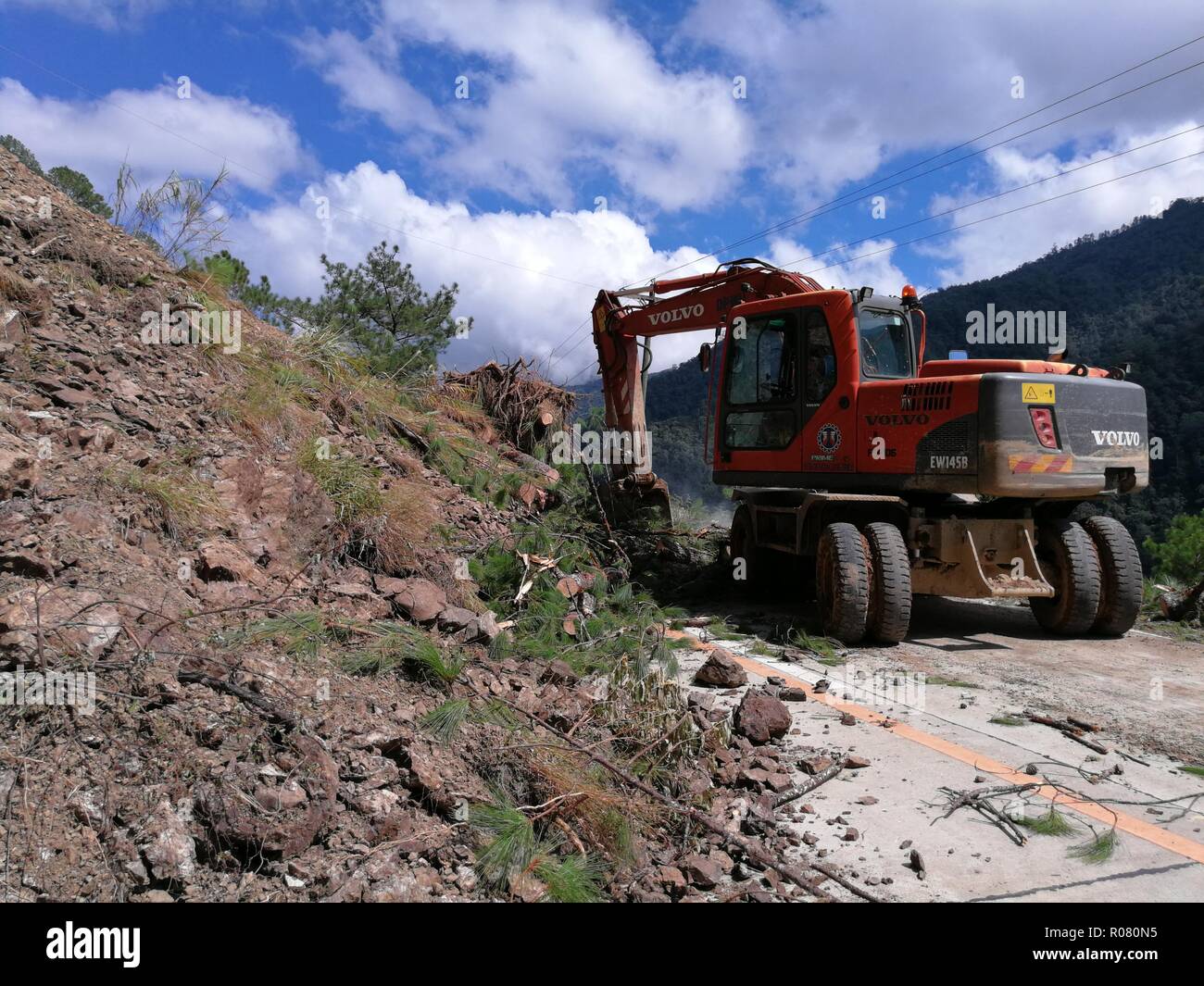 Clearing the landslide going to Natonin town in the Mountain Province ...