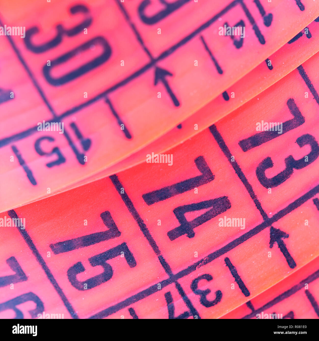 in the white light rotation of a red measure tape like concept measure ...