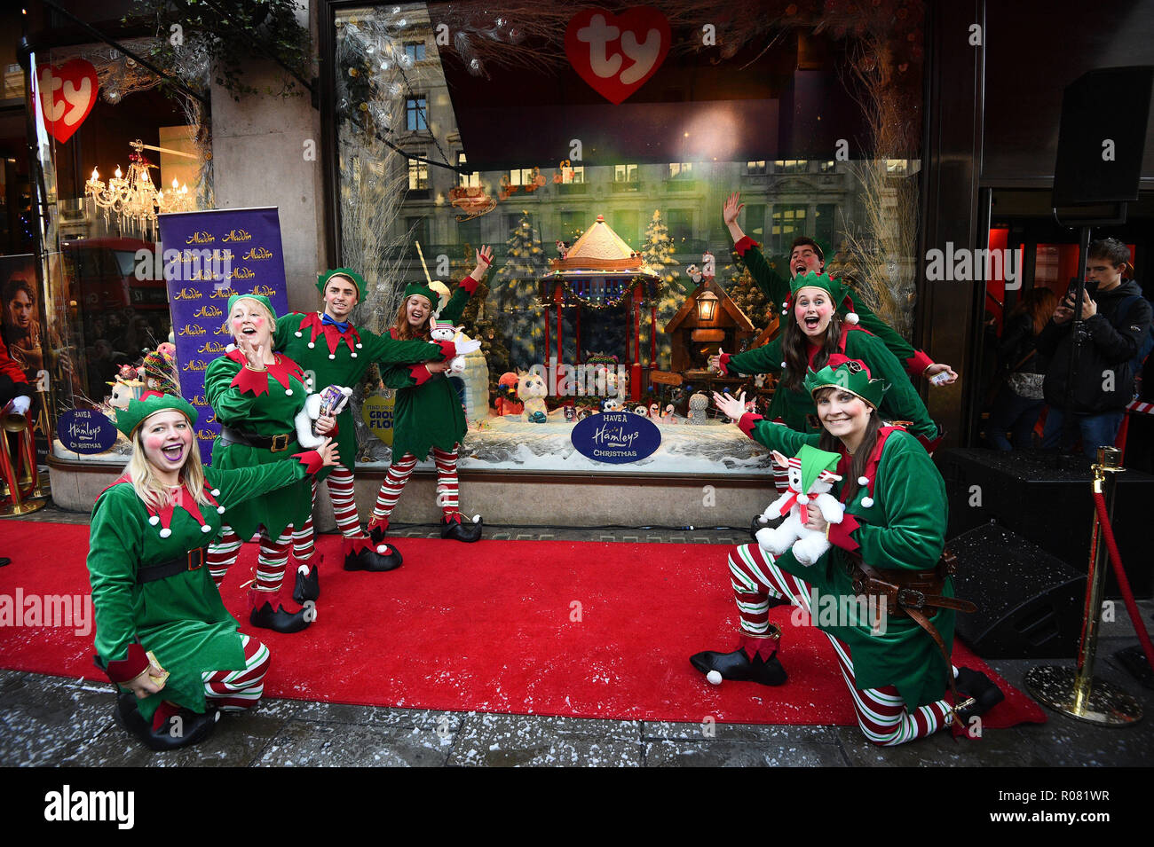 Hamleys employees dressed as Elves unveil the Christmas window display ...