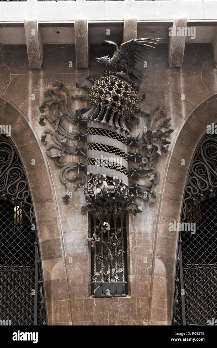 Decorative metal ornament with a bird on the the wall of the Palau ...