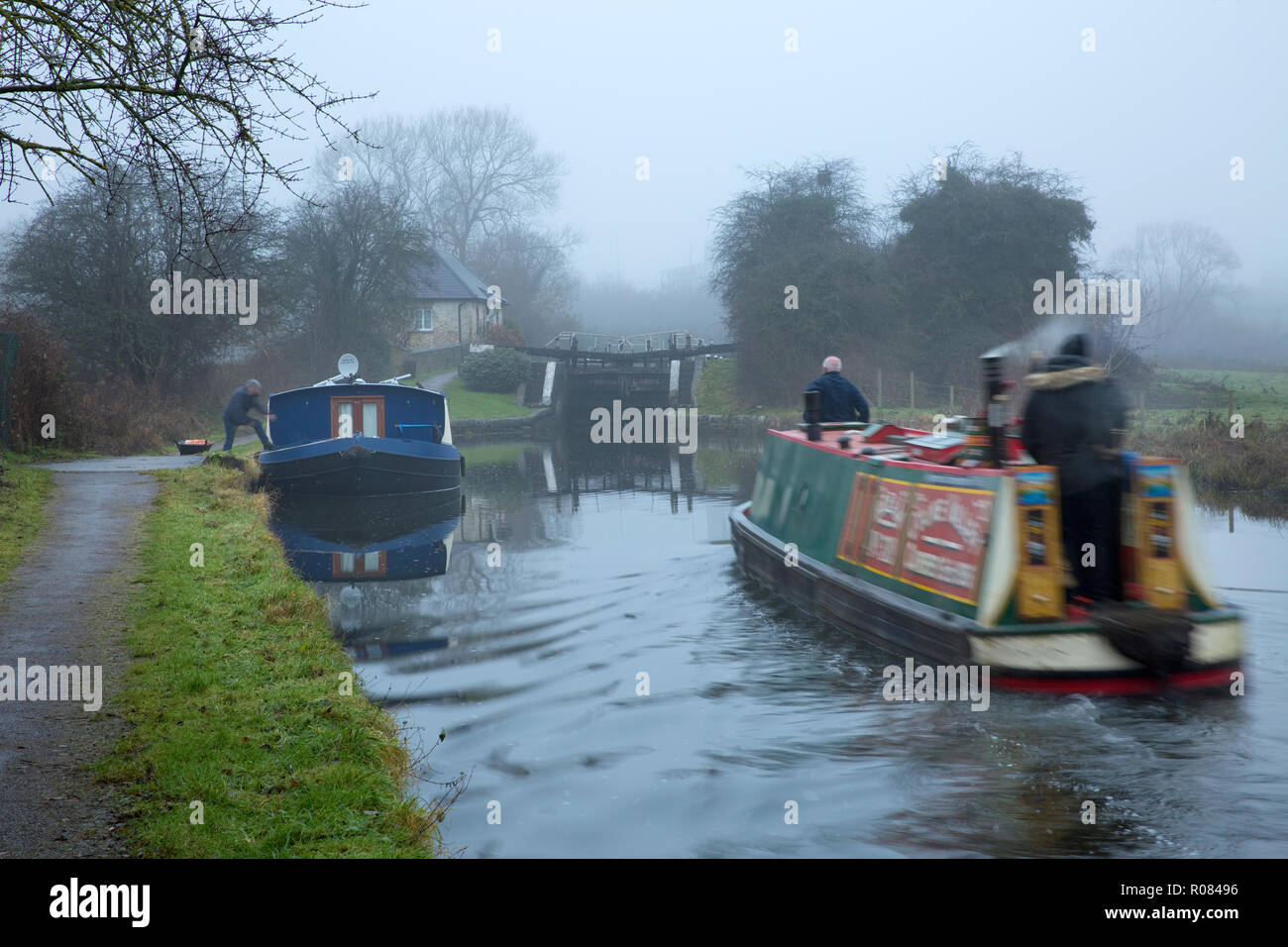 Traditional narrowboat approaching lock on the Grand Union Canal ...