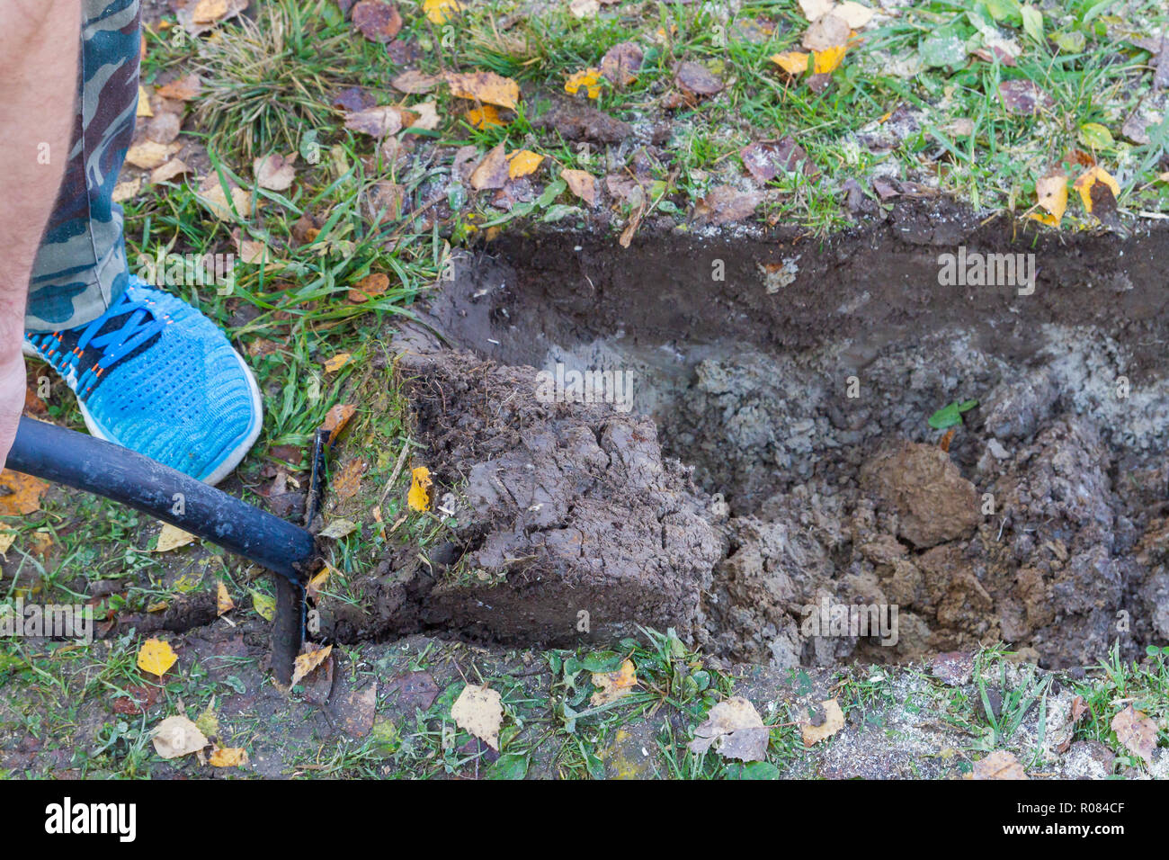Man digging a ditch with a shovel in autumn Stock Photo - Alamy