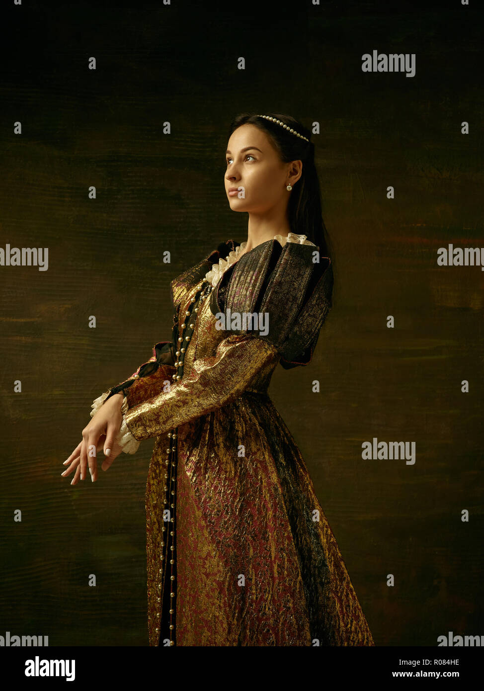 Girl in medieval beautiful dress or costume of the countess at dark ...