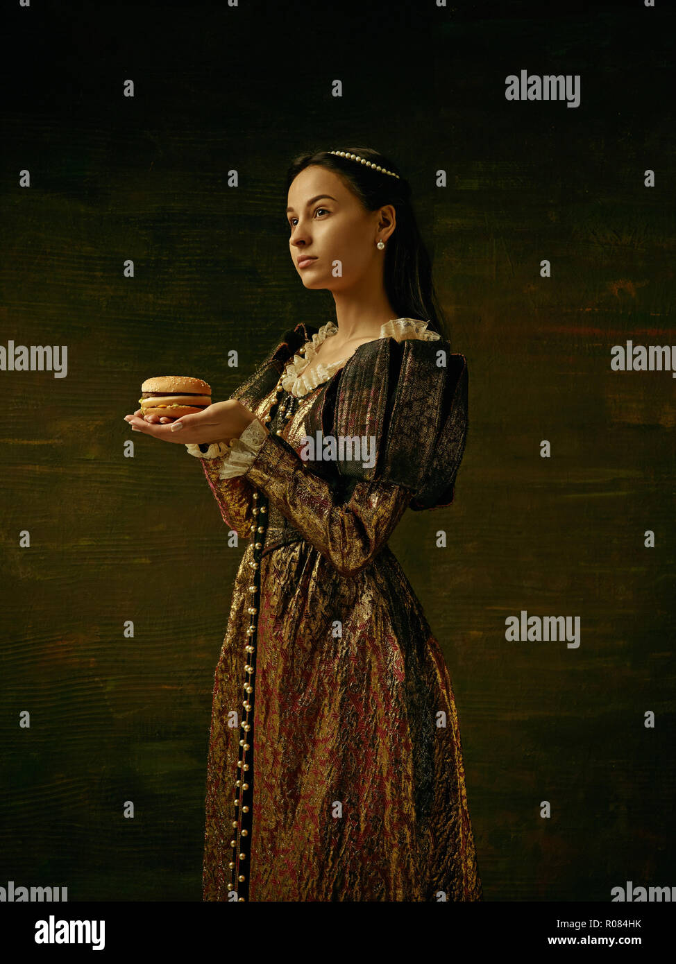 Girl in medieval beautiful dress or costume of the countess at dark ...