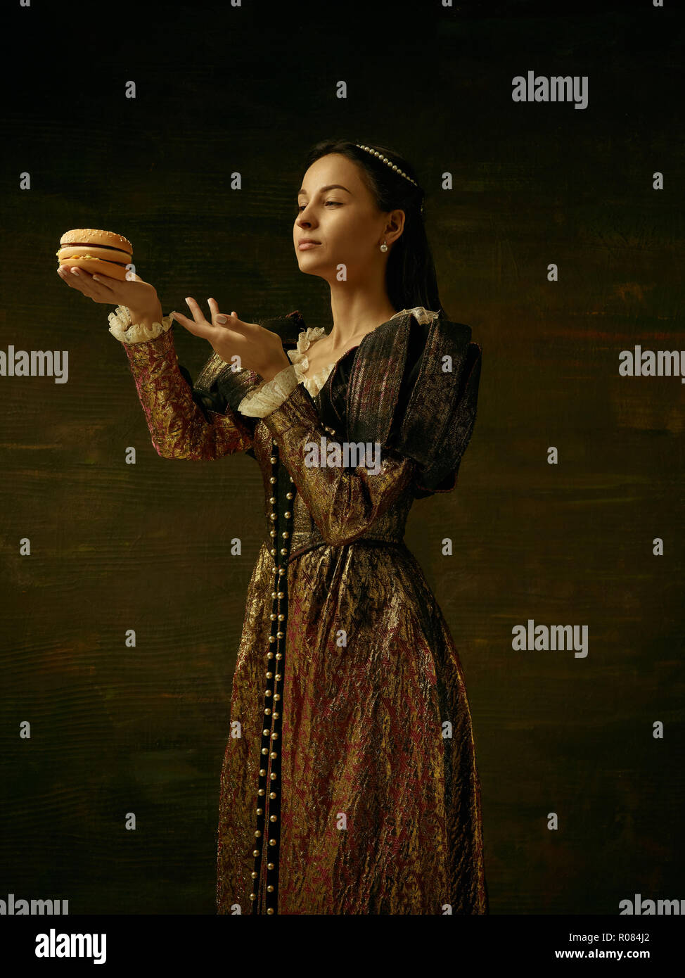 Girl in medieval beautiful dress or costume of the countess at dark ...