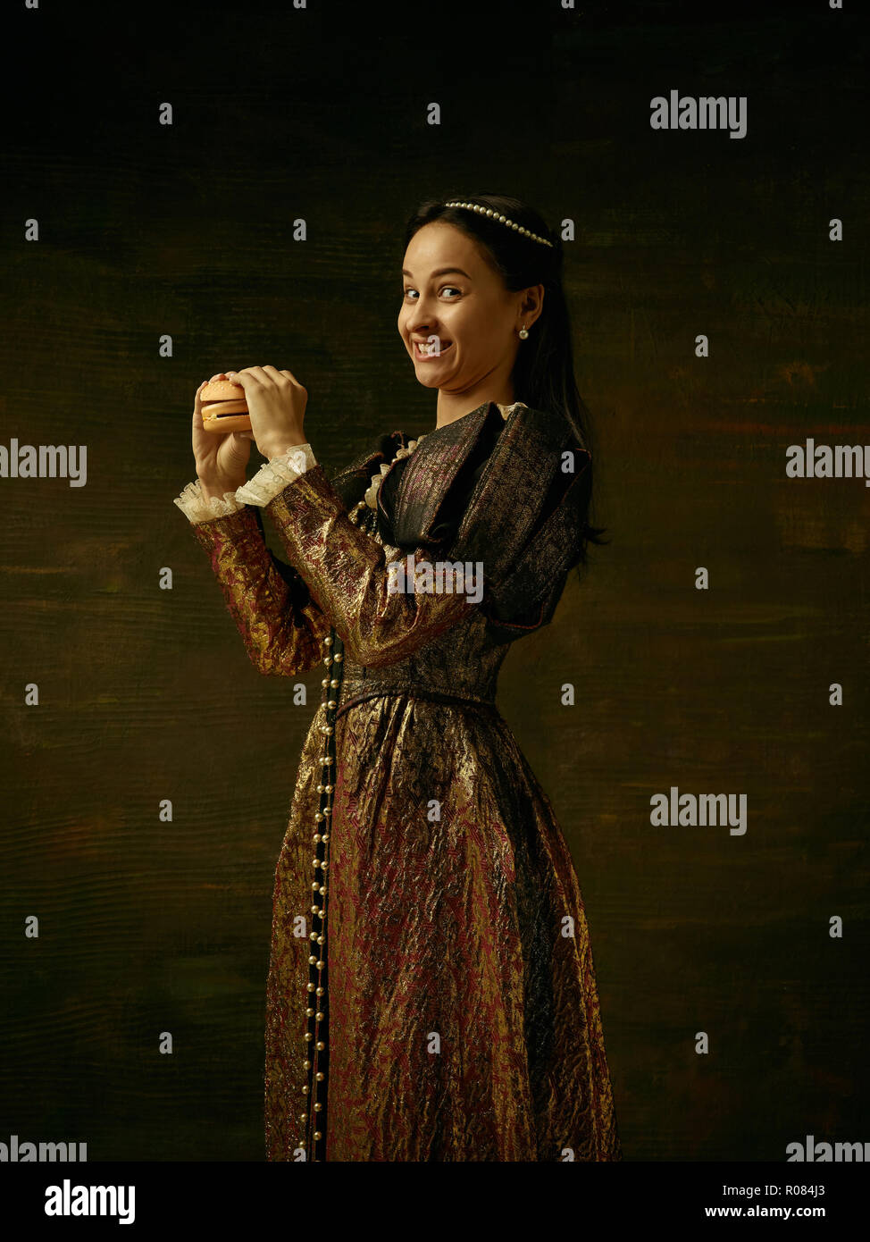 Girl in medieval beautiful dress or costume of the countess at dark ...