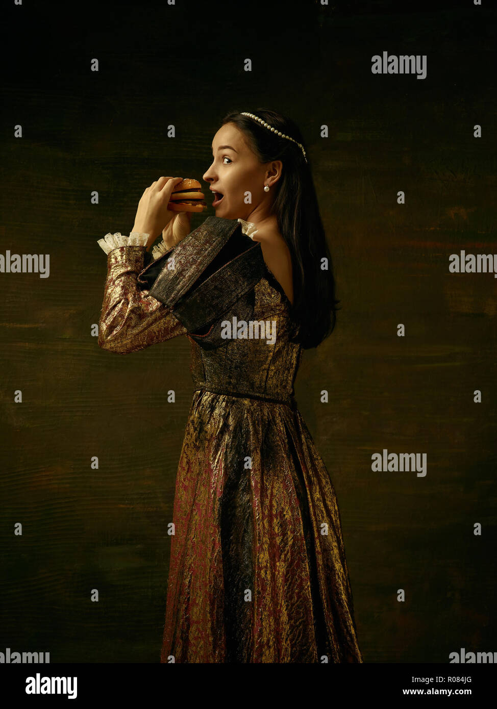 Girl in medieval beautiful dress or costume of the countess at dark ...