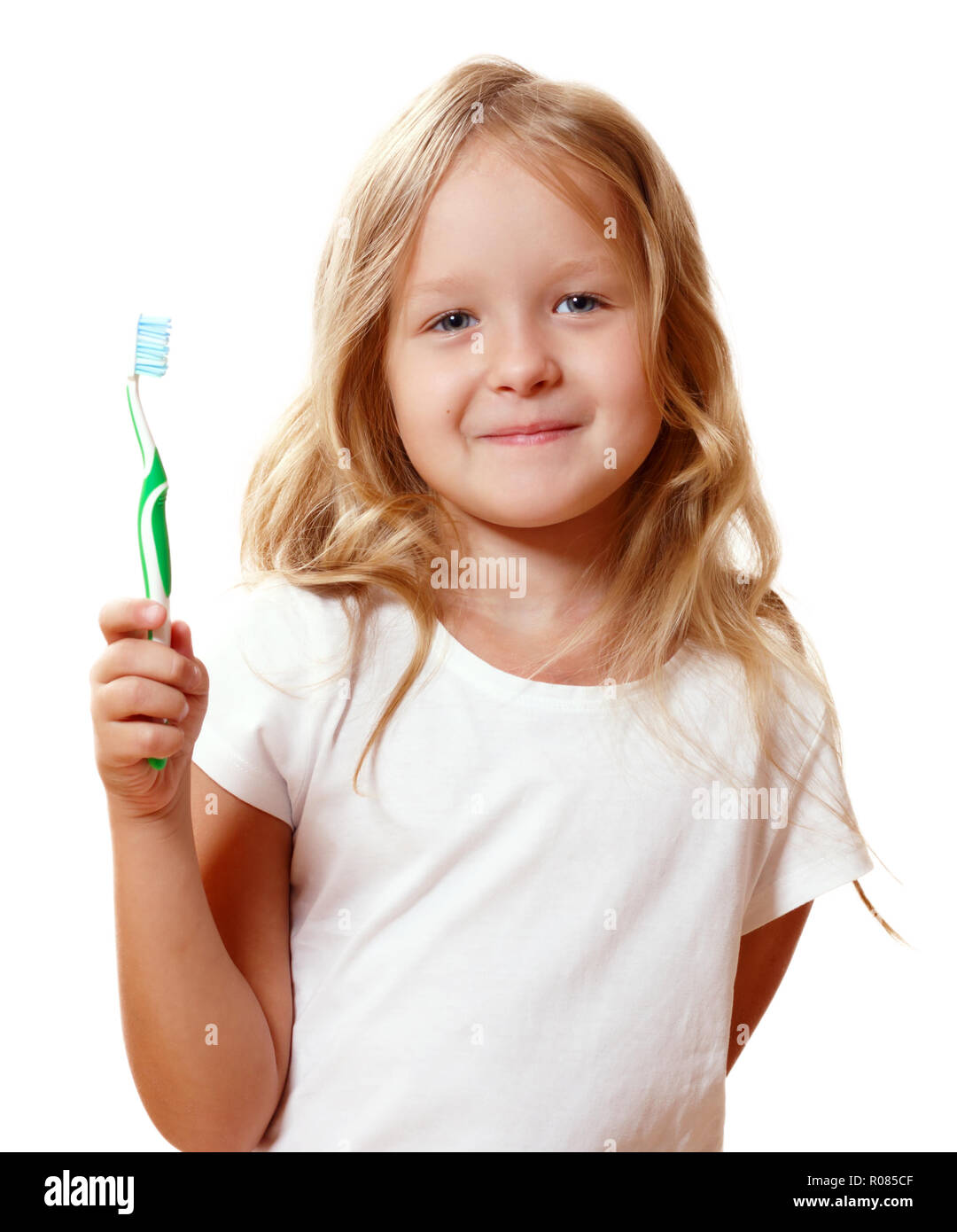 A little kid girl is brushing her teeth with a toothbrush. The concept ...