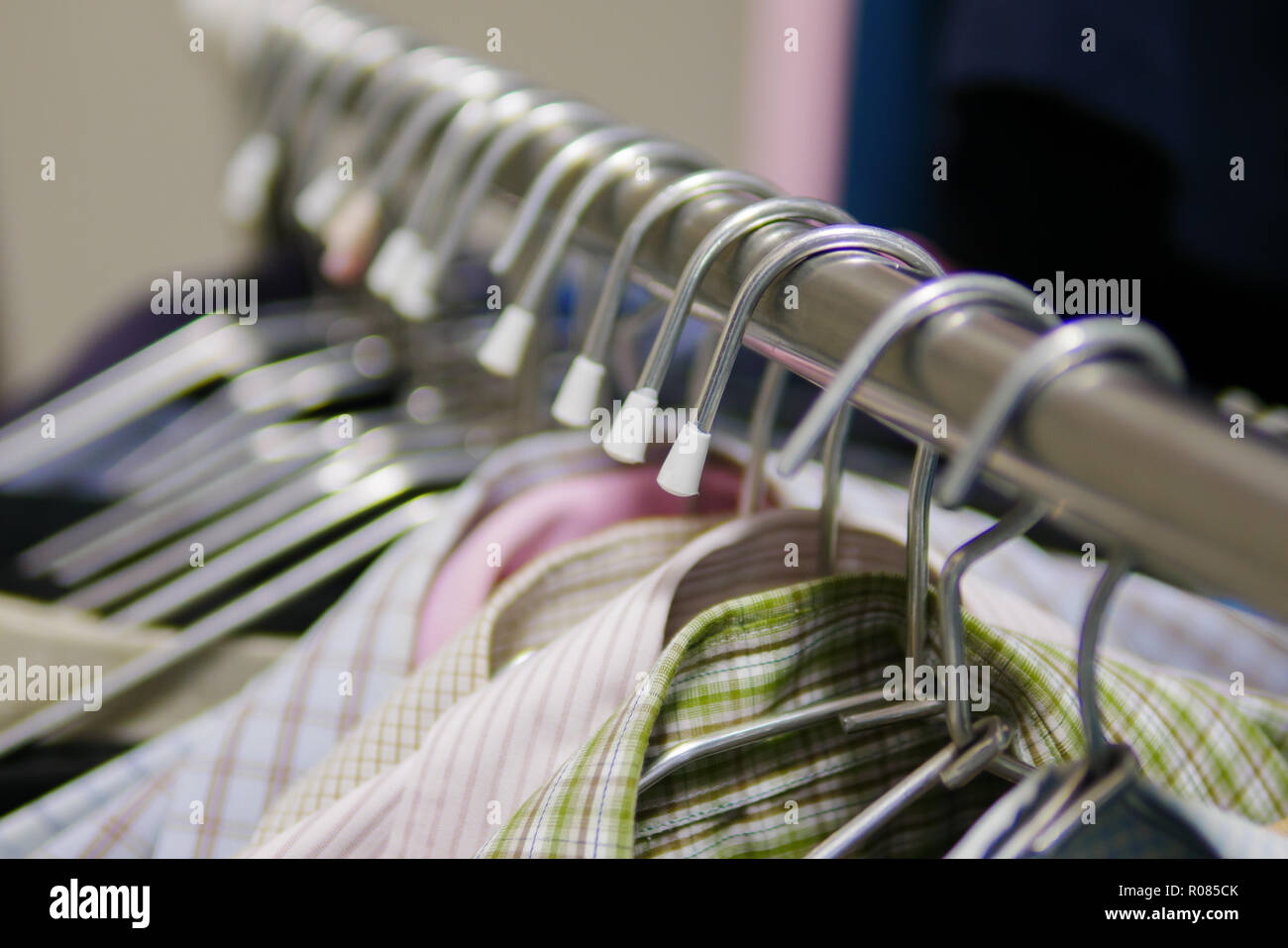 Men shirts on clothes rack Stock Photo - Alamy