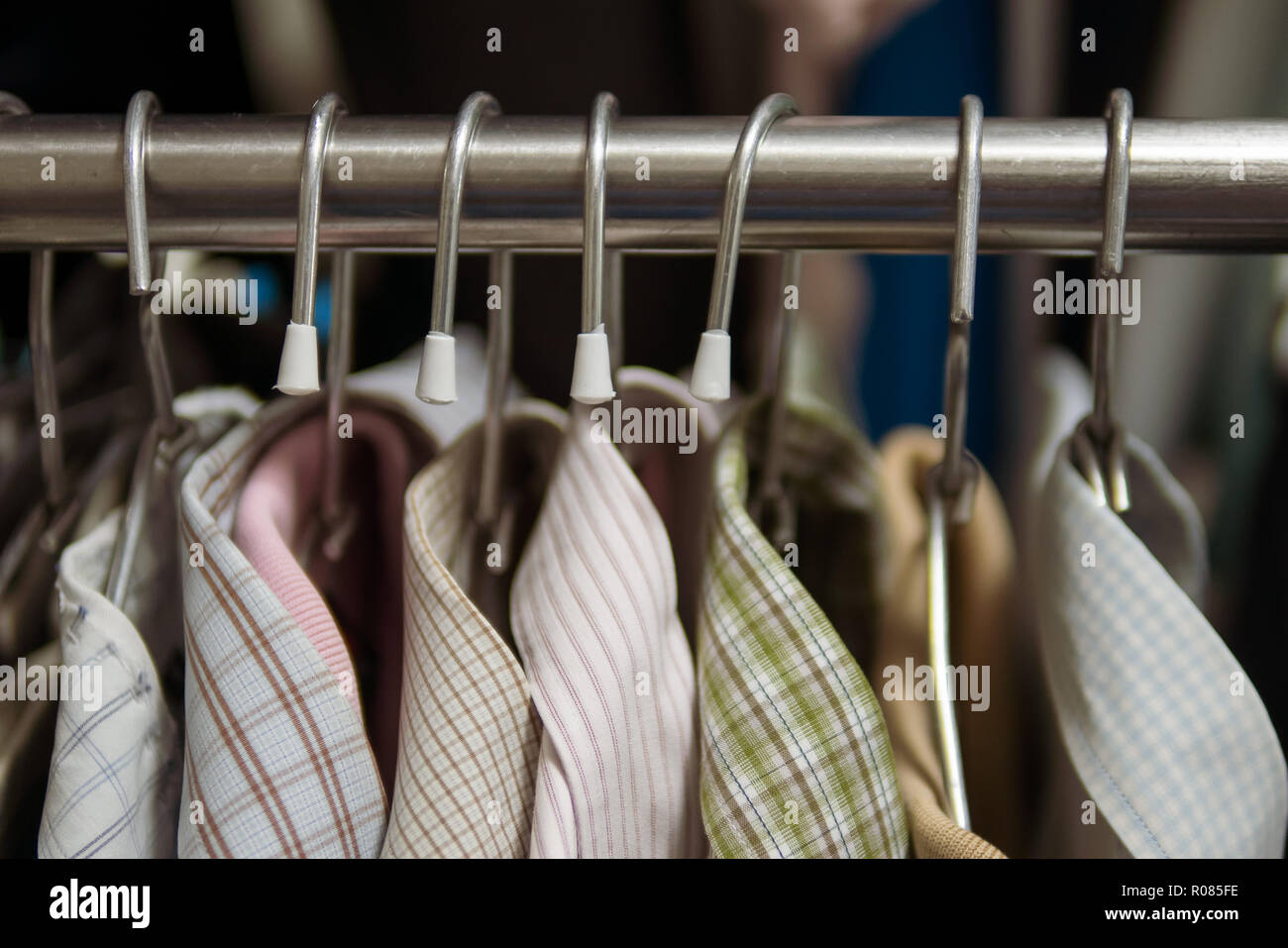 Men shirts on clothes rack Stock Photo - Alamy