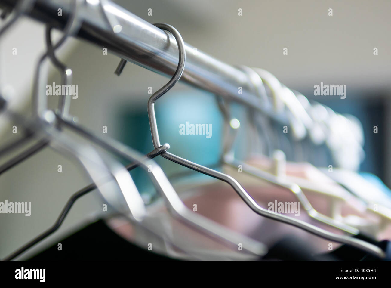 Clothes hangers on the rack Stock Photo - Alamy