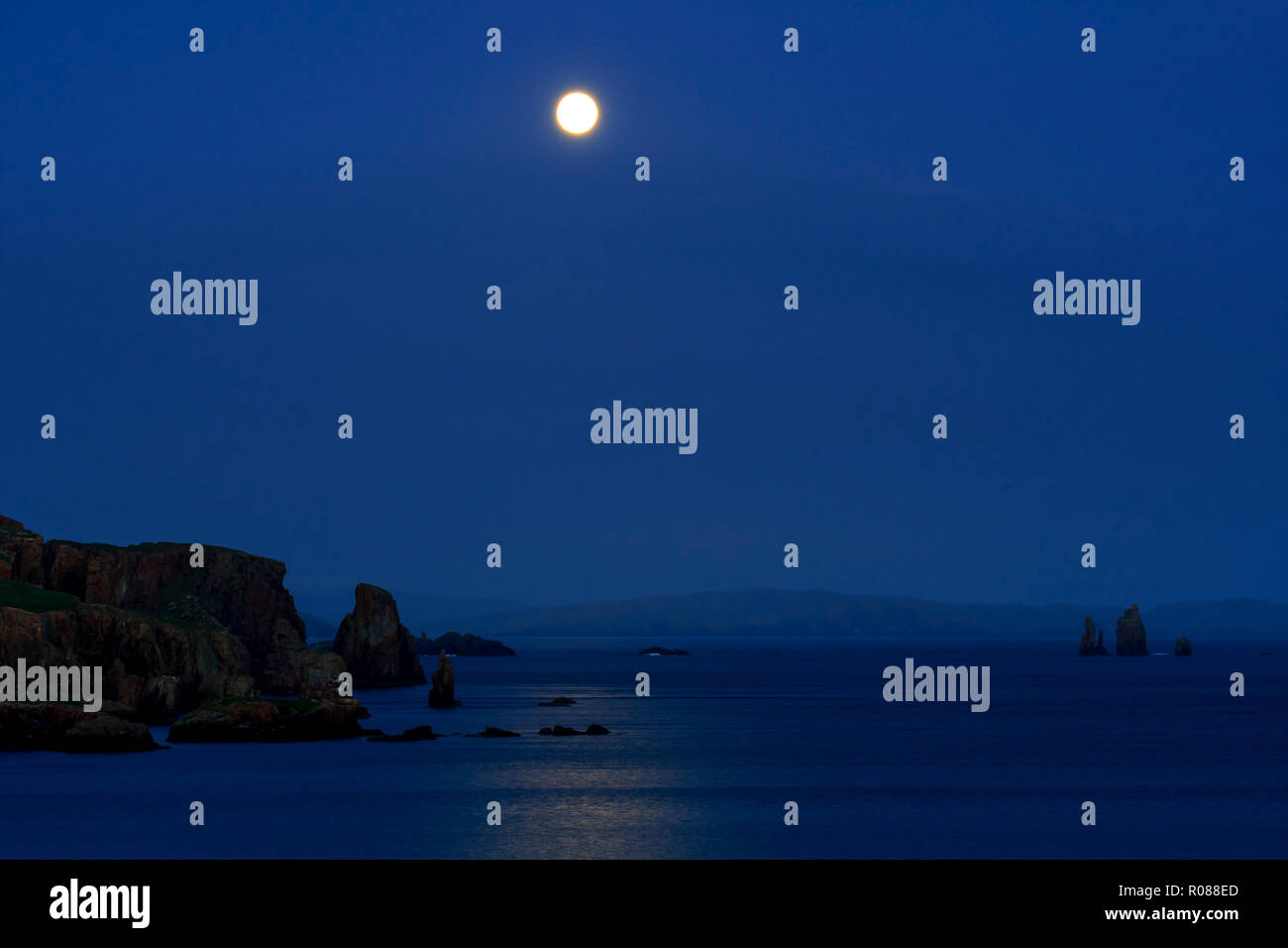 The Drongs at night with full moon, sea stacks in St Magnus Bay near ...