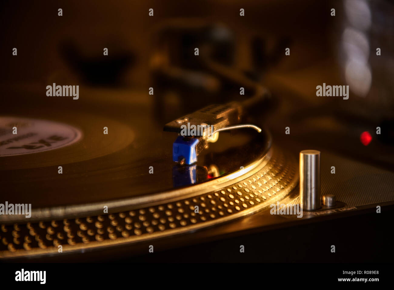 Detail of a vintage record player taken in a disco with soft light ...