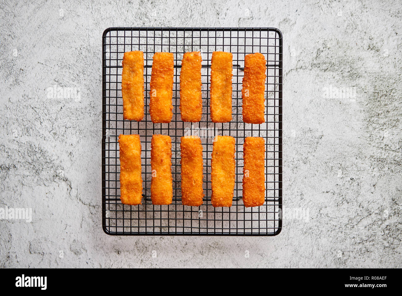 Rows of golden fried fresh fish fingers fillets Stock Photo - Alamy